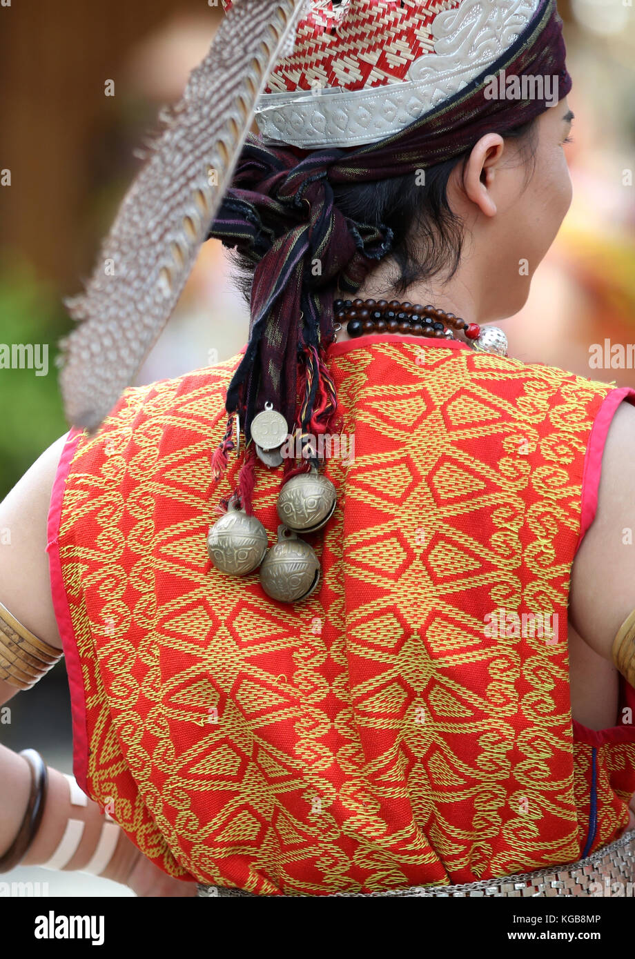 A woman in traditional dress from the Sarawak Cultural Village ahead of ...