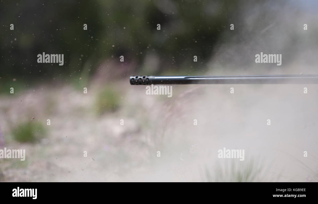Gravel and dust airborne after a shot from a rifle Stock Photo - Alamy