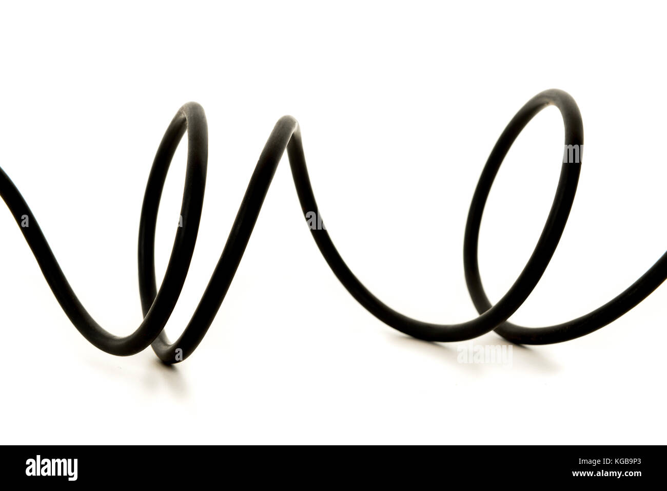 Curled shaped black wire cable on a white background Stock Photo - Alamy