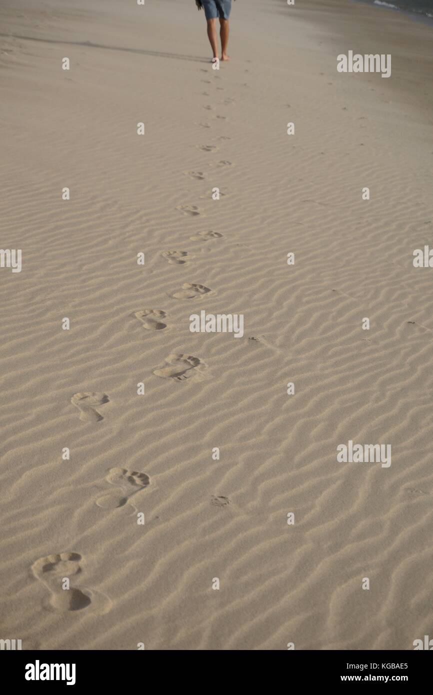 Footsteps on beach on white sand Stock Photo - Alamy