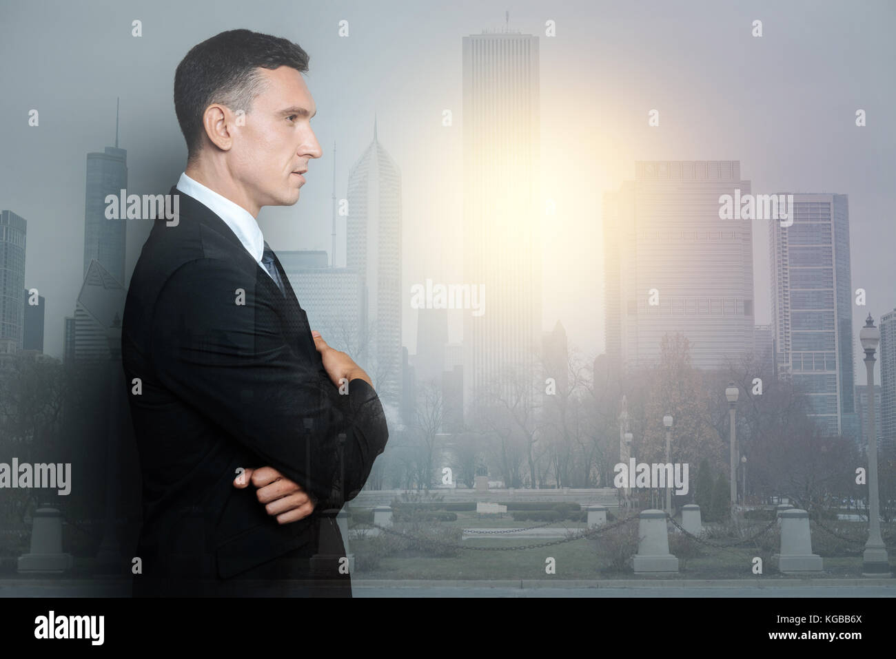 Confident nice man standing cross handed Stock Photo - Alamy