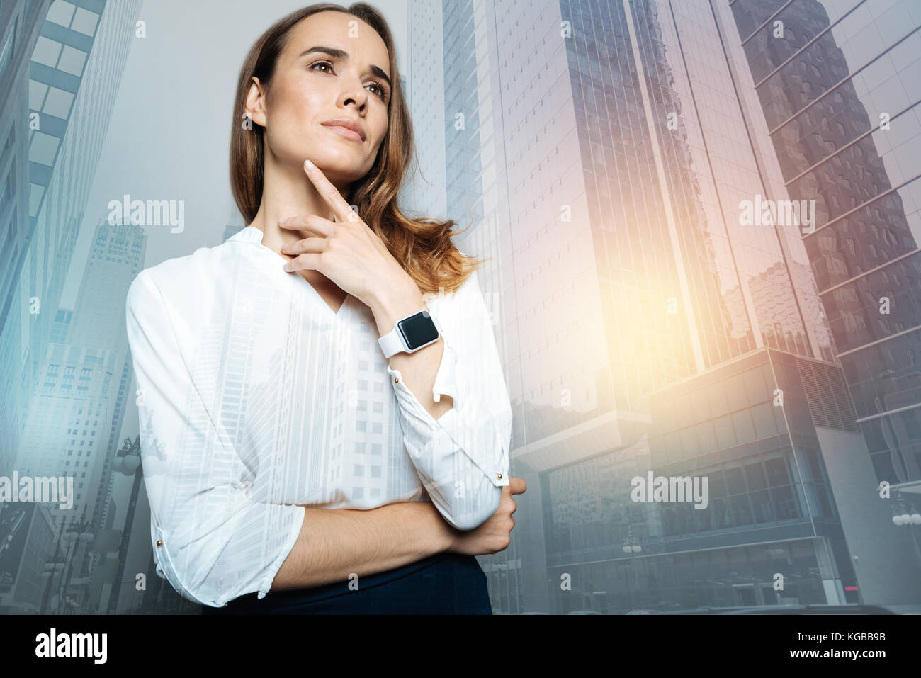 Pleasant young woman thinking about her work Stock Photo - Alamy