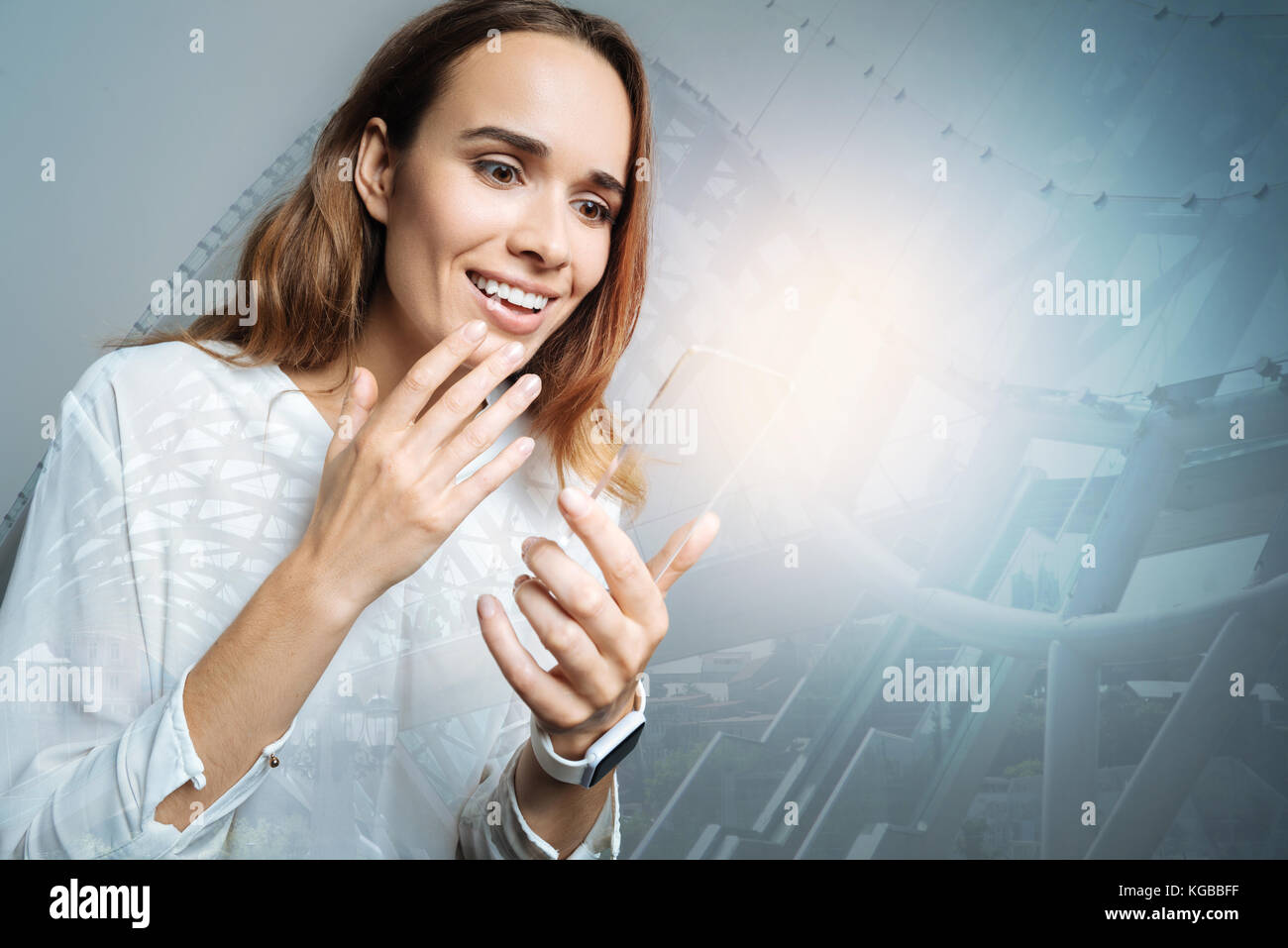 Positive happy woman holding her gadget Stock Photo - Alamy