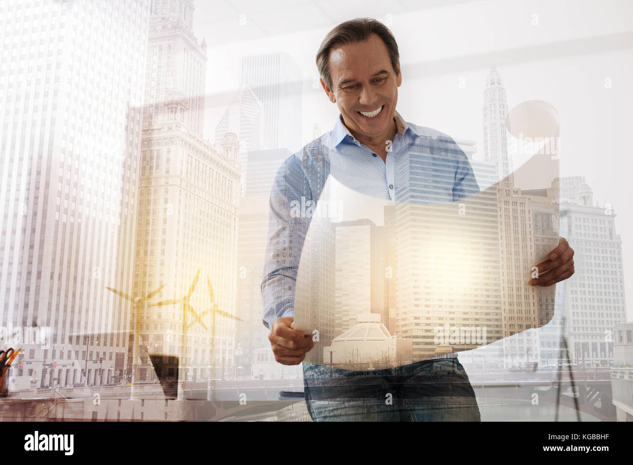 Professional eco engineer holding a blueprint Stock Photo - Alamy