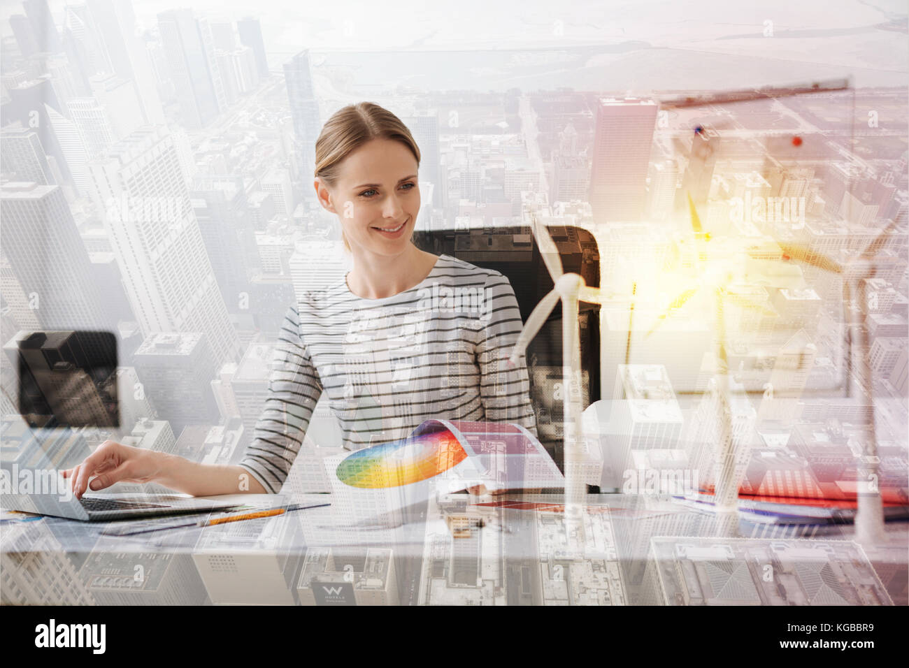 Cheerful female eco engineer working on te eco project Stock Photo - Alamy