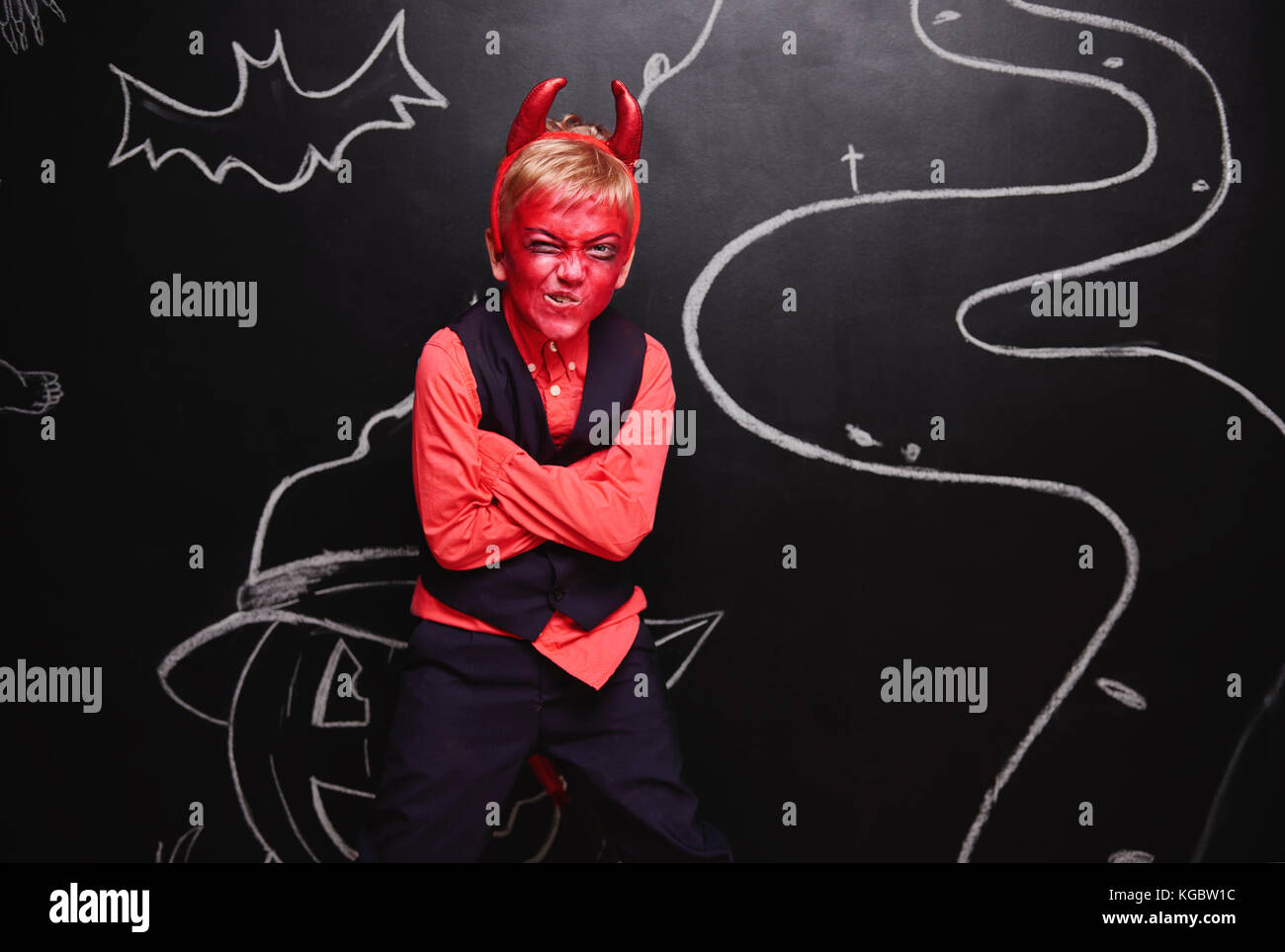 Kid celebrating Halloween in devil costume Stock Photo - Alamy