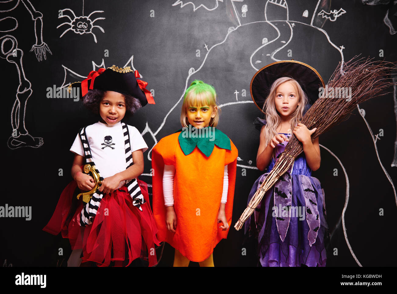 Happy friends wearing halloween costumes Stock Photo - Alamy