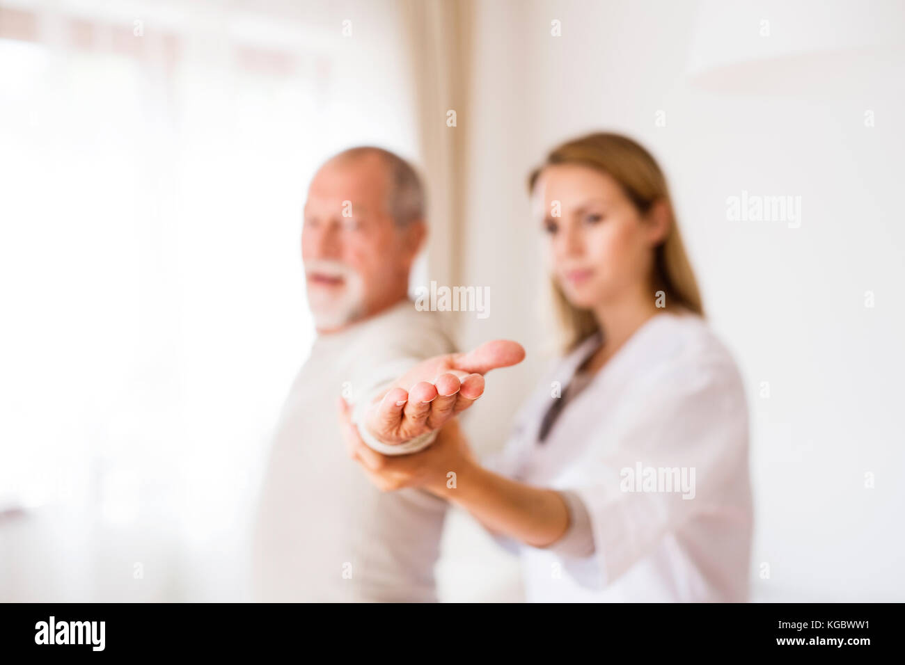 Health visitor and senior man during home visit Stock Photo - Alamy