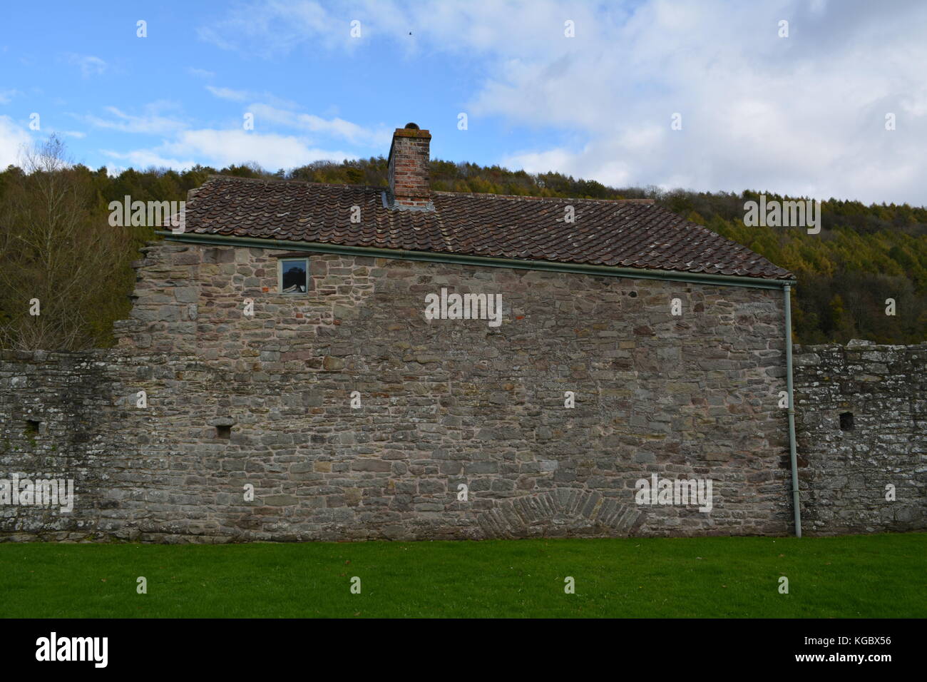 old red sandstone wall elevation of a building with clay tile roof ...