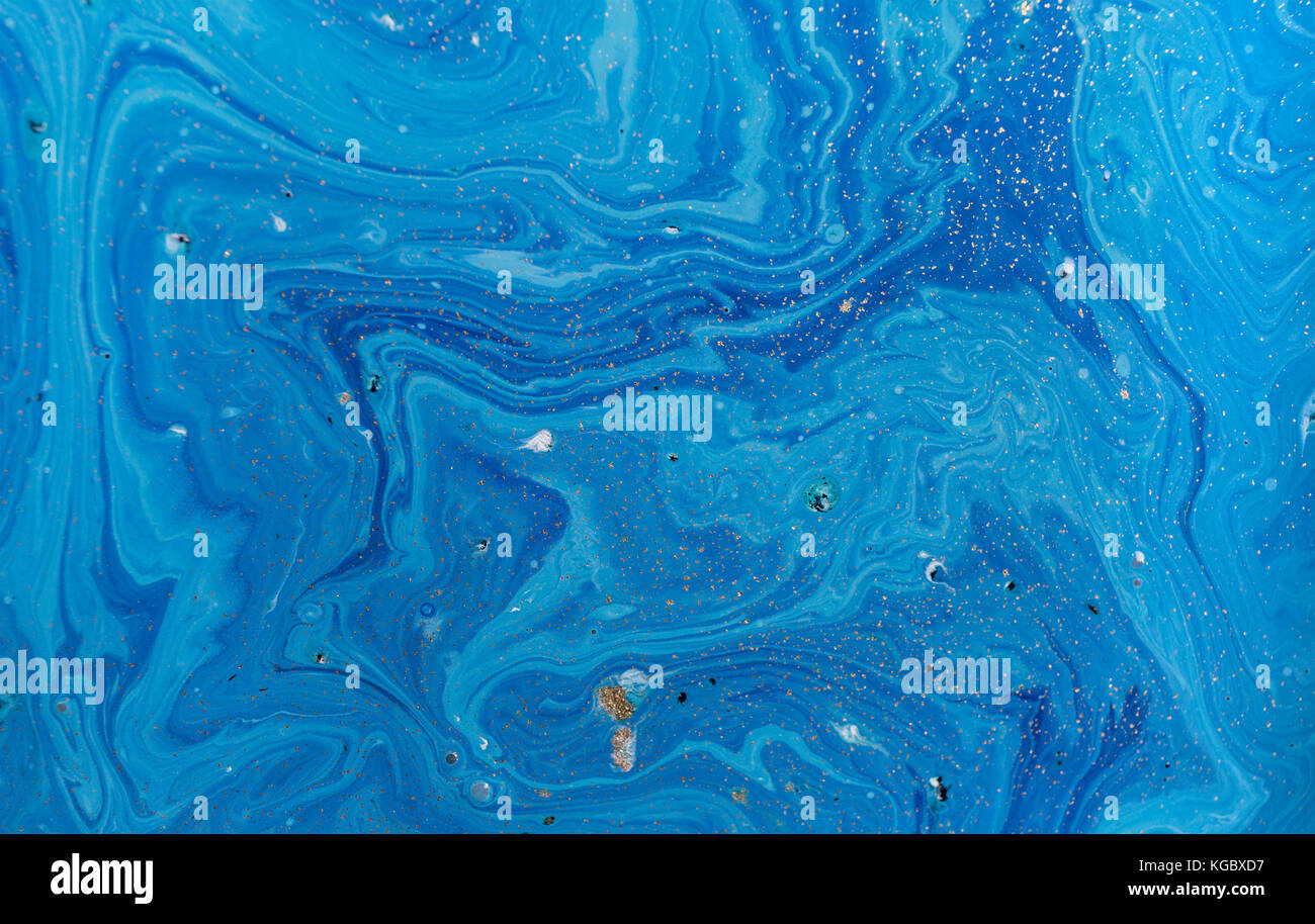 Marbled blue abstract background with golden sequins. Liquid marble ink ...