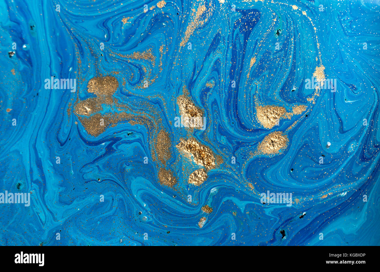 Marbled blue abstract background with golden sequins. Liquid marble ink ...