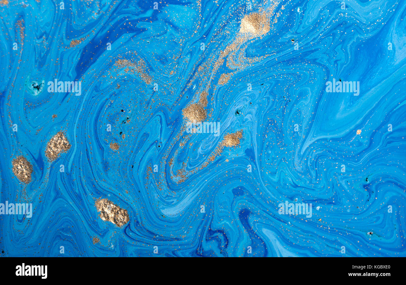 Marbled blue abstract background with golden sequins. Liquid marble ink ...