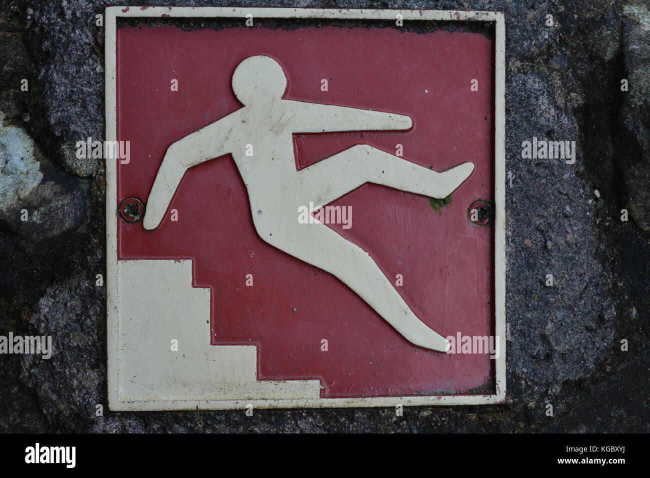 old square metal sign with red and white paint showing figure falling ...