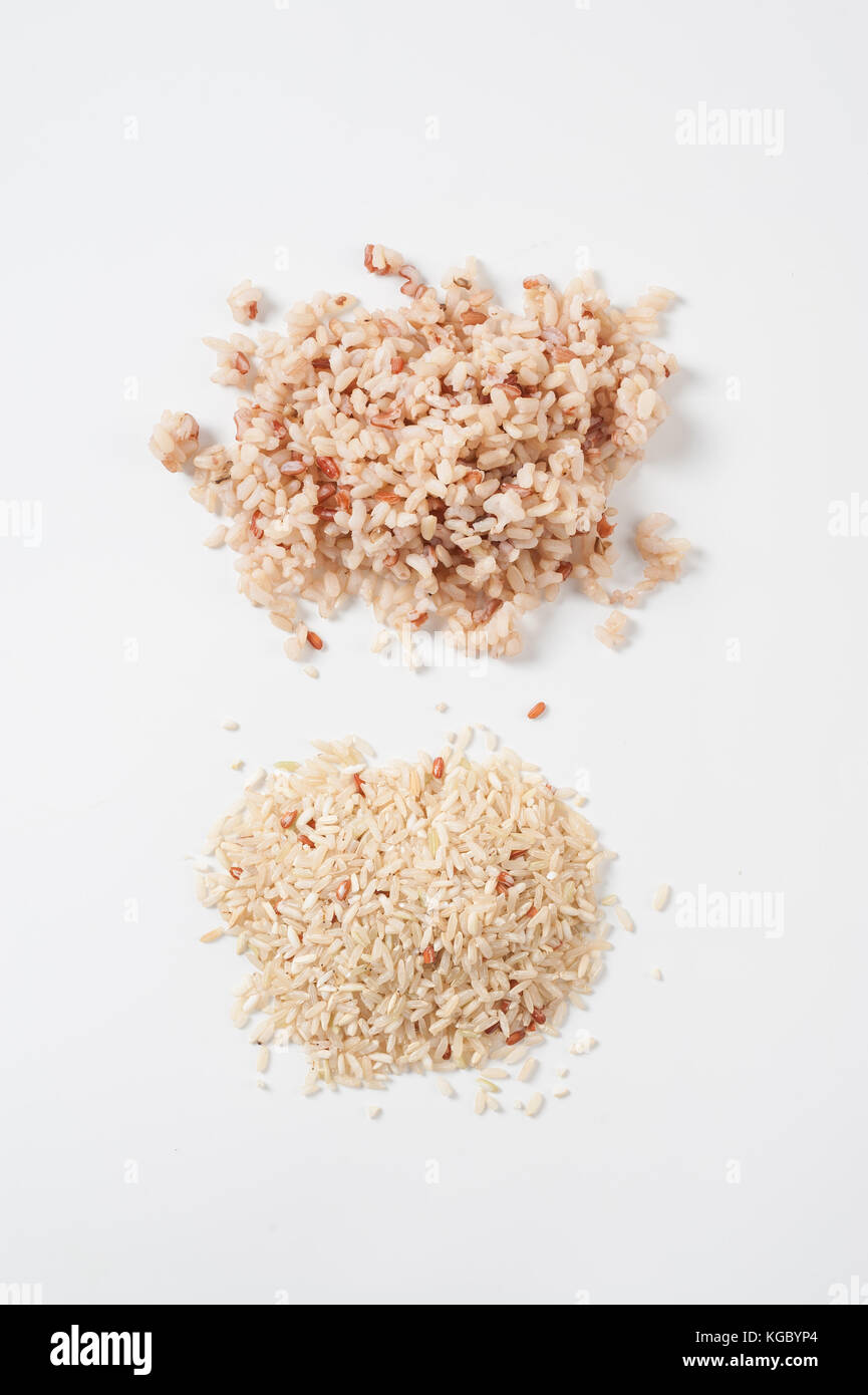 Cooked and uncook brown rice (unpolished Thai jasmine rice) on white ...