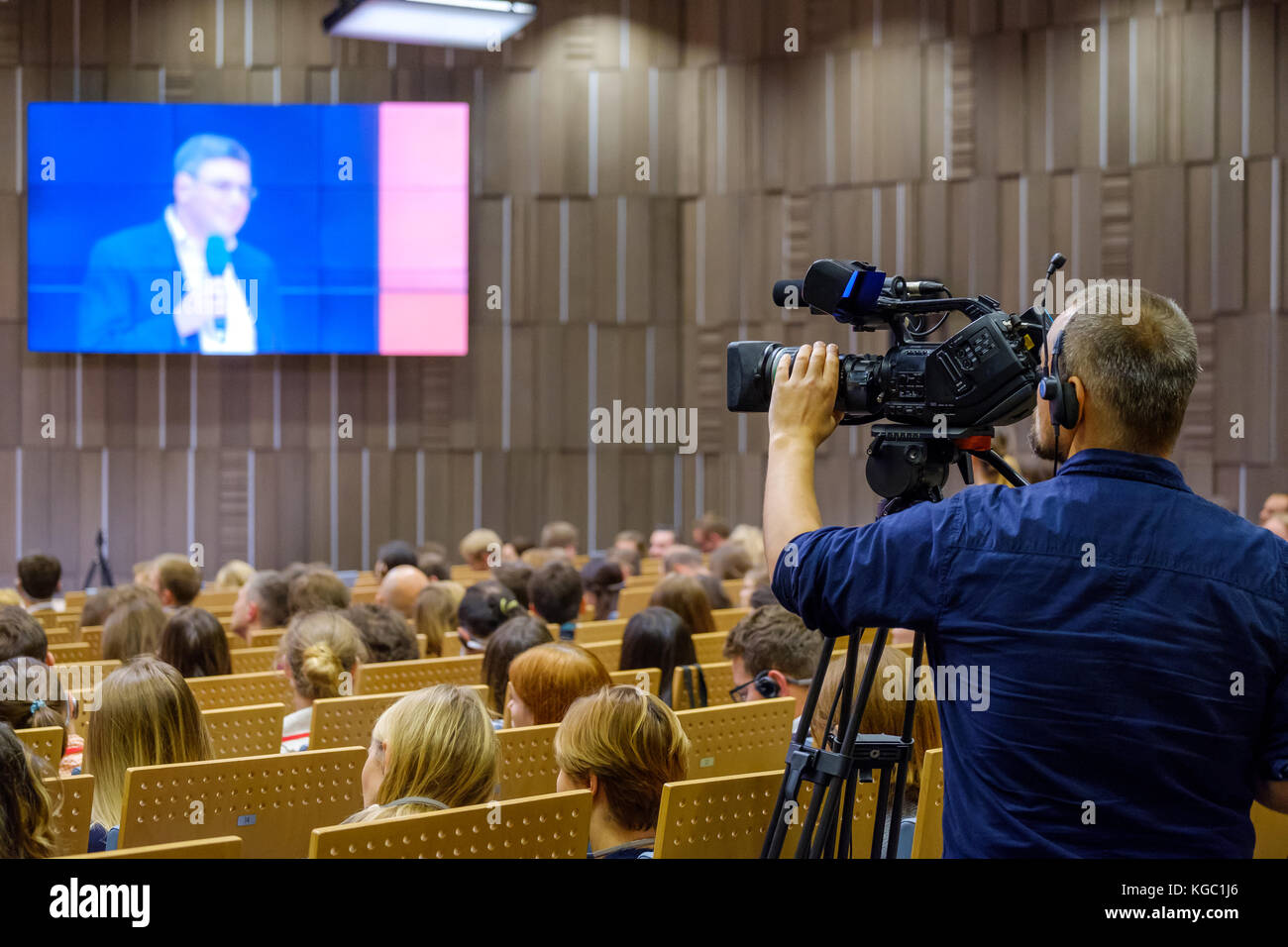 Videographer makes online broadcast at the conference Stock Photo - Alamy