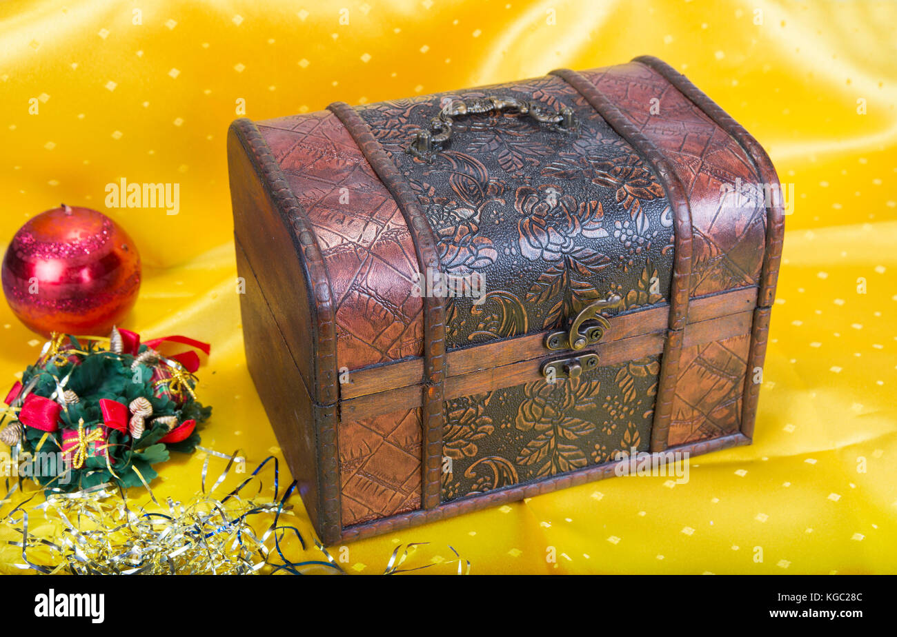 Christmas background with decorations bells, ribbon and balls and chest ...