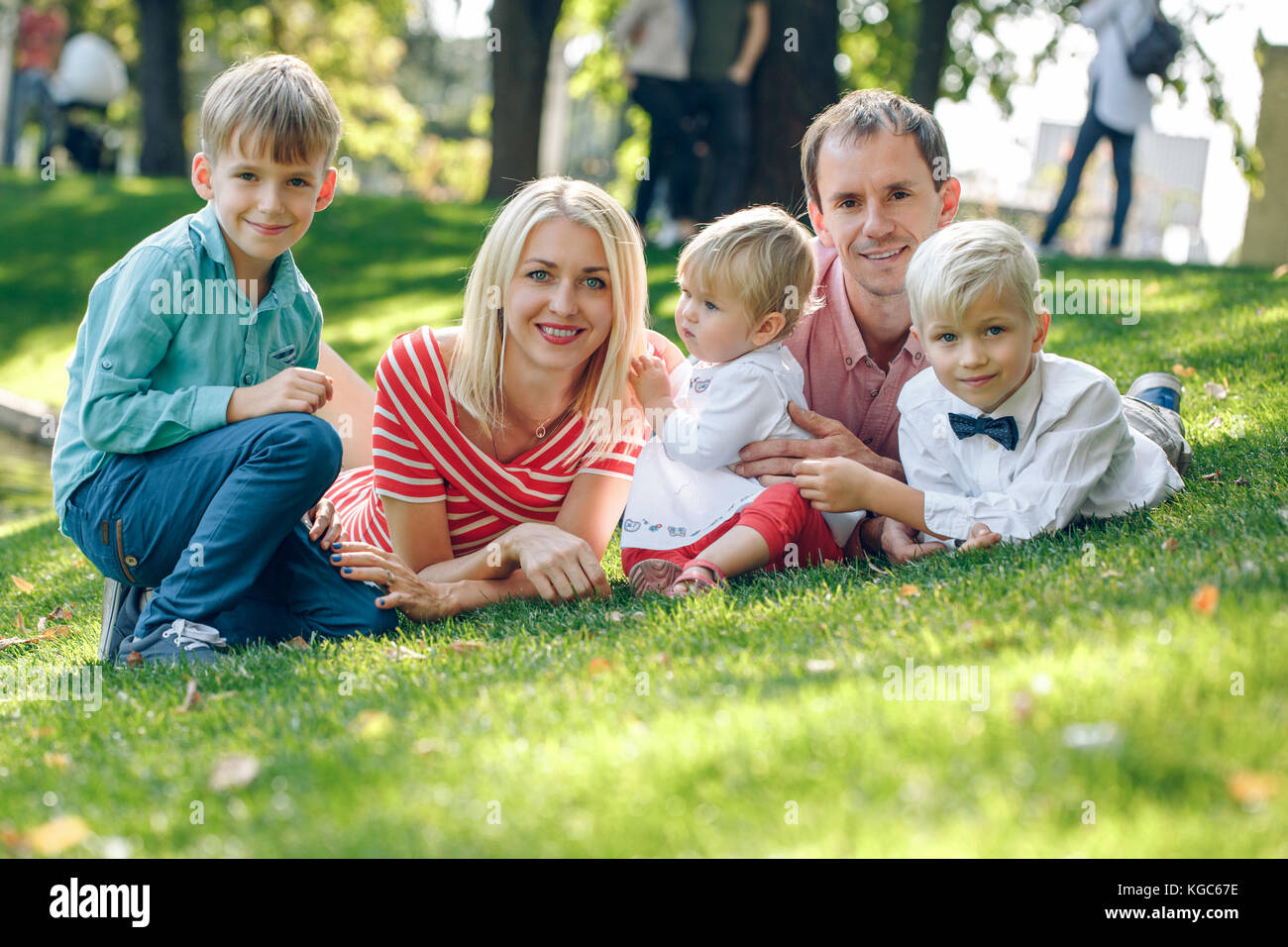 Happy young family with three children in park Stock Photo - Alamy