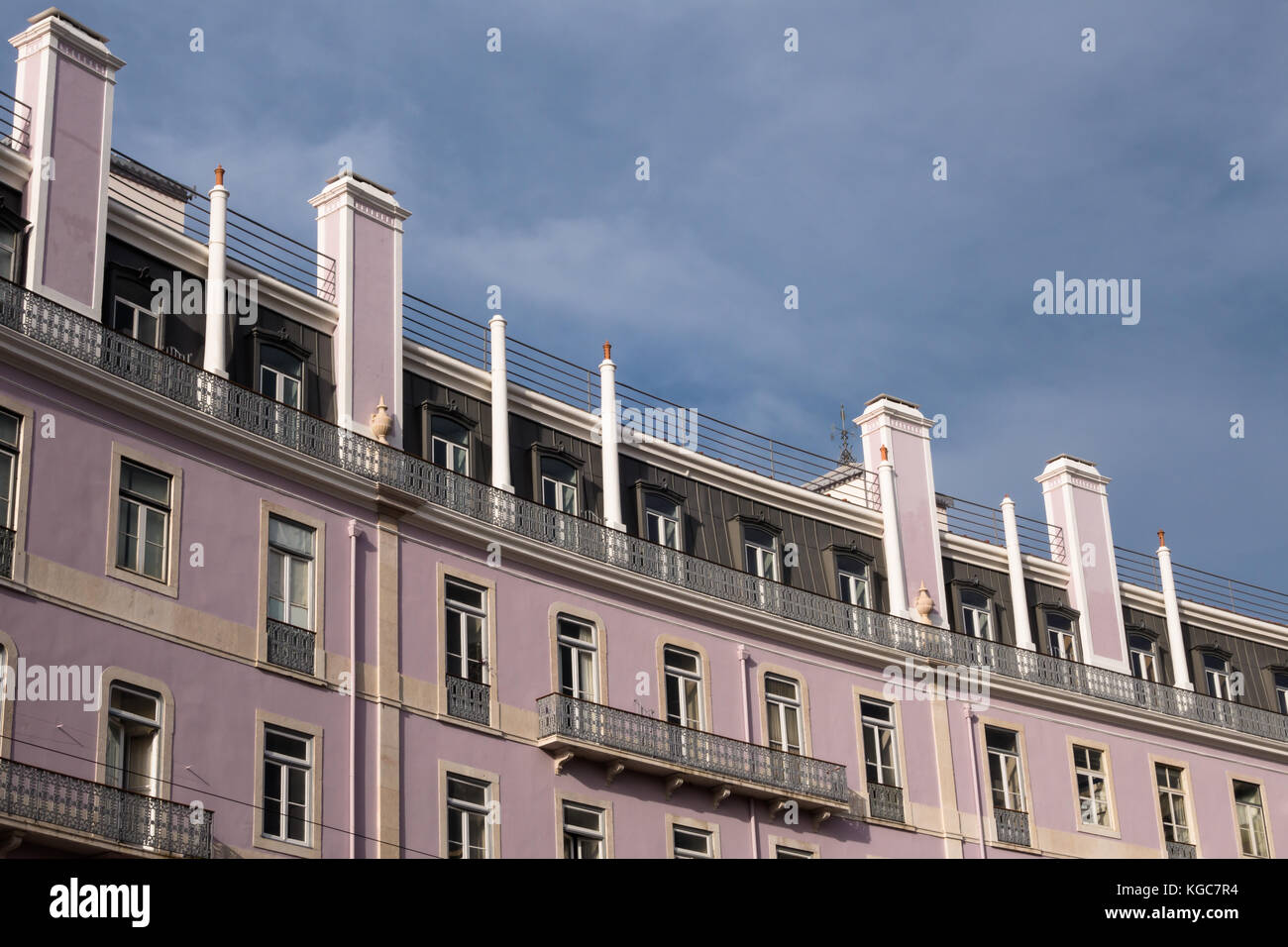 Curving apartment building facade with rows of windows chimneys ...