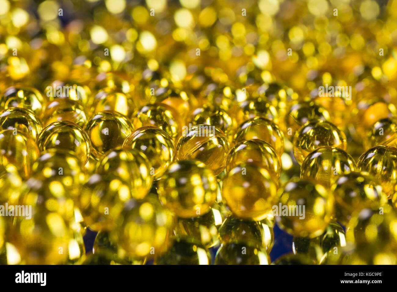 yellow medical capsules on a mirror surface Stock Photo - Alamy