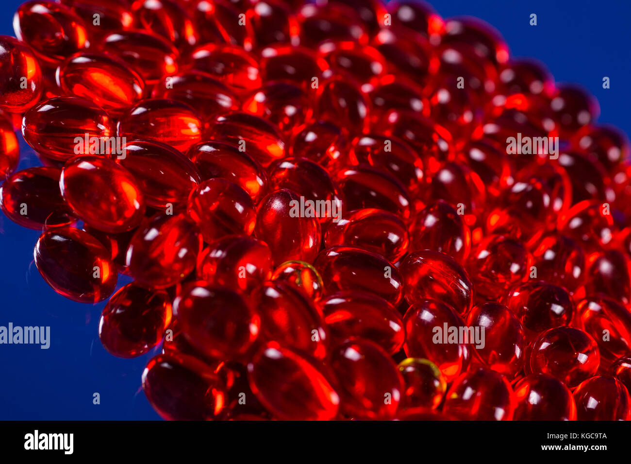 red medical capsules on a mirror surface Stock Photo - Alamy
