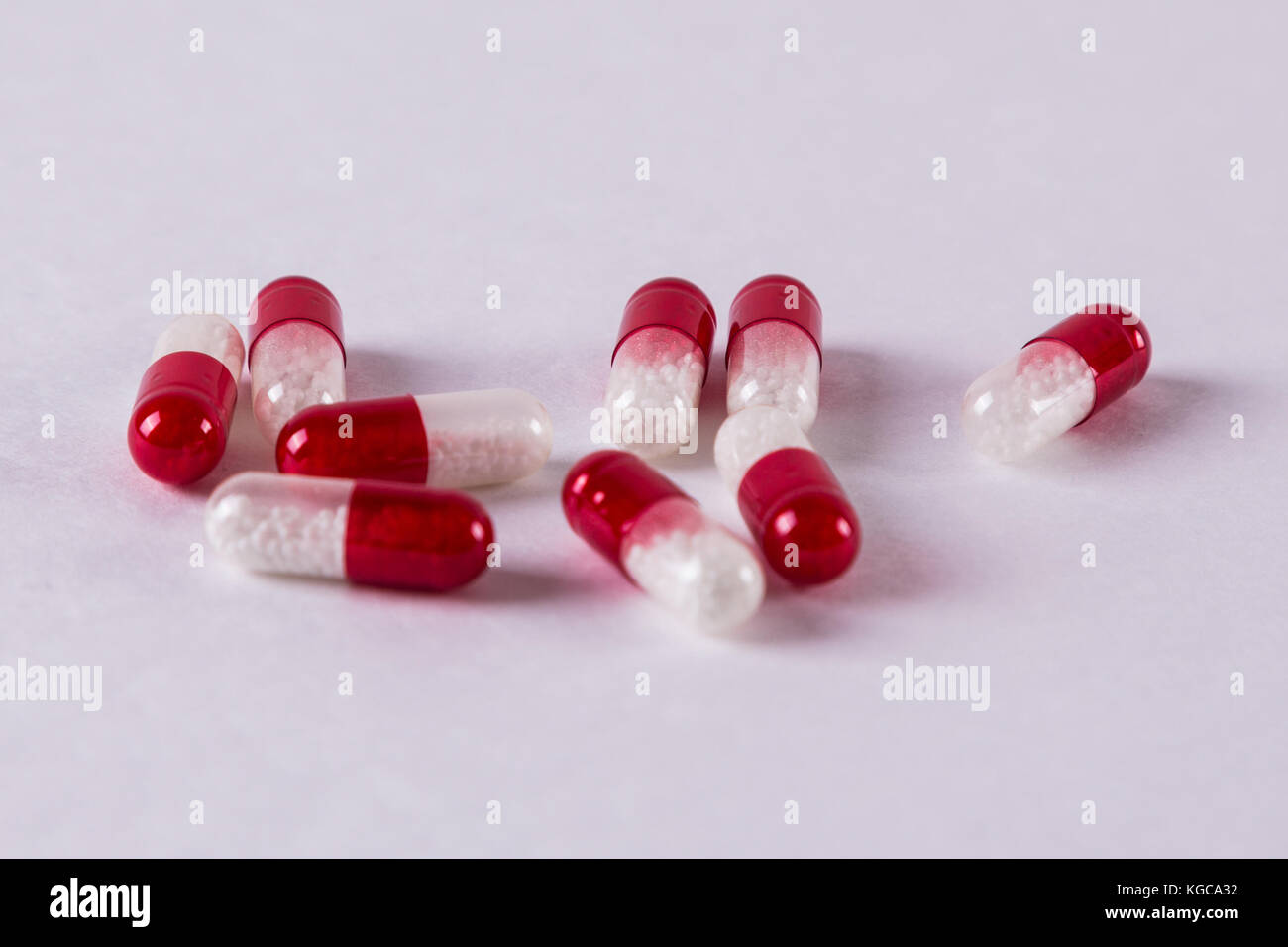 red-white capsules on a white background Stock Photo - Alamy