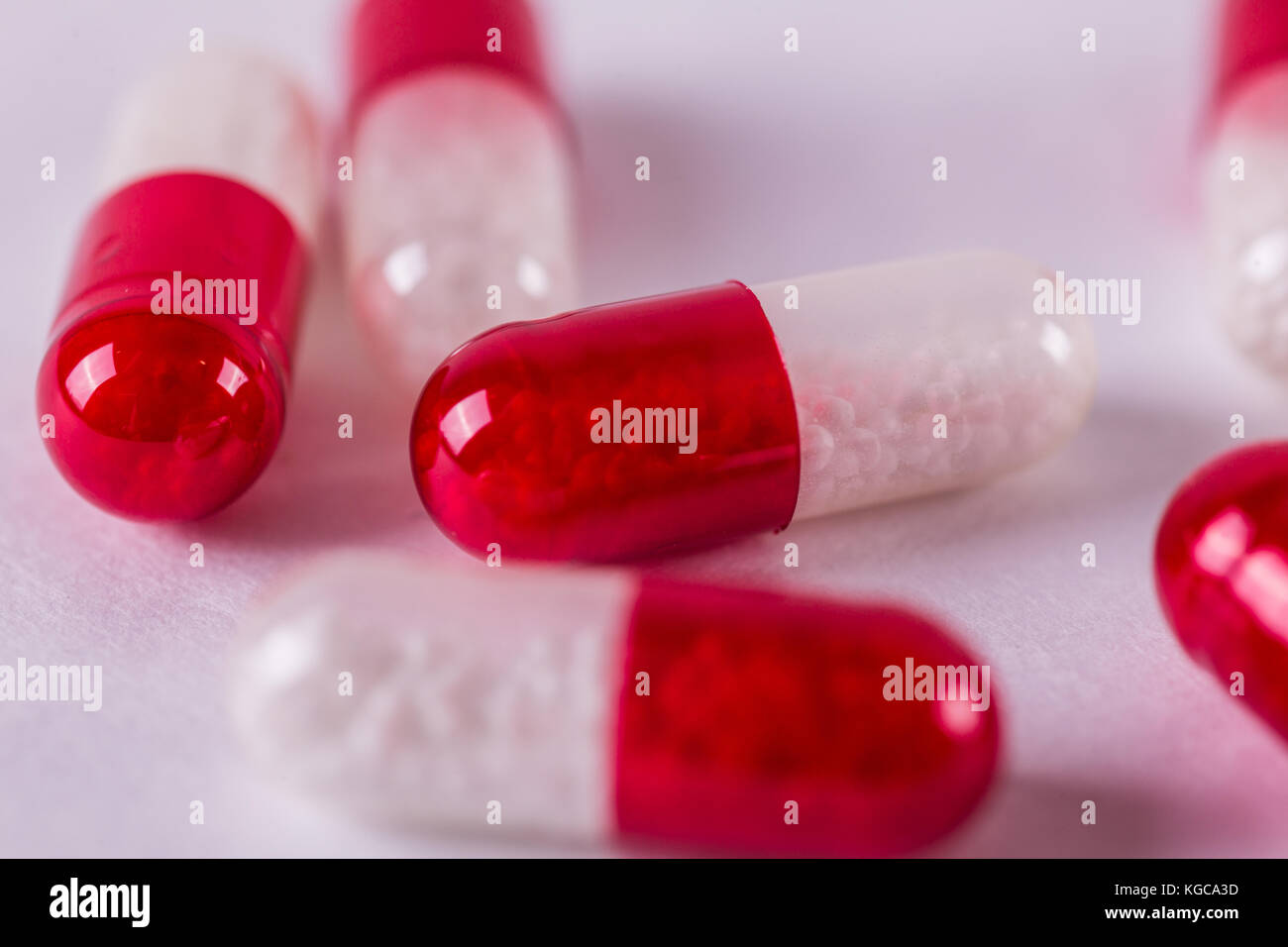 red-white capsules on a white background Stock Photo - Alamy