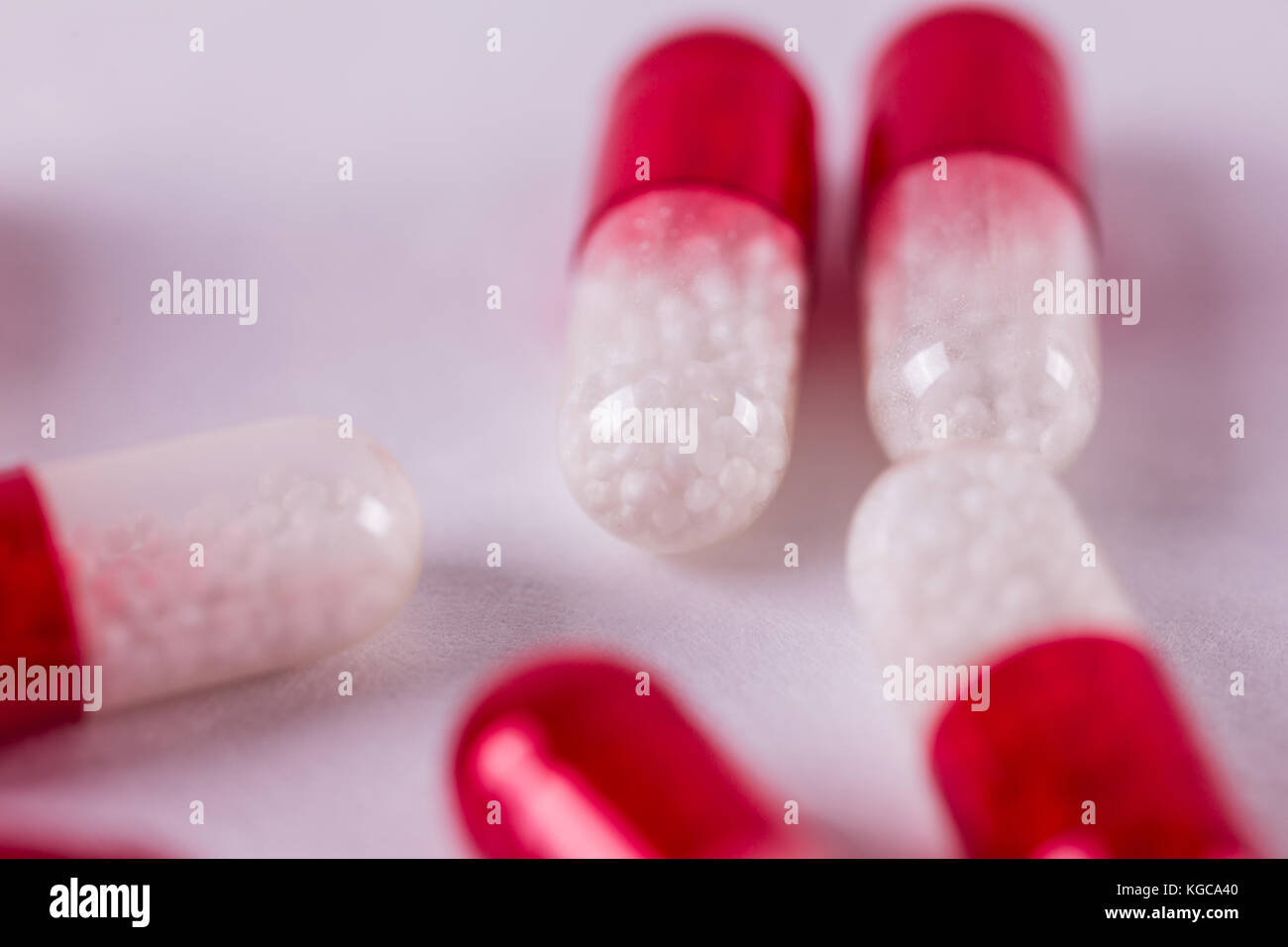 red-white capsules on a white background Stock Photo - Alamy