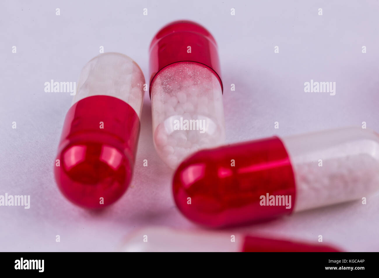 red-white capsules on a white background Stock Photo - Alamy