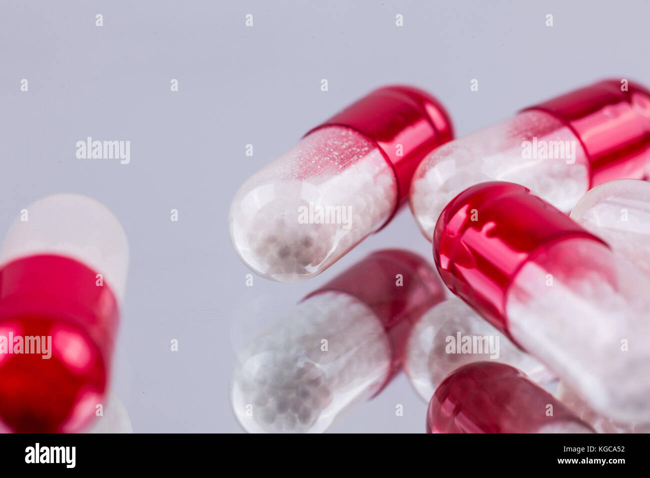 red-white capsules on a white background Stock Photo - Alamy
