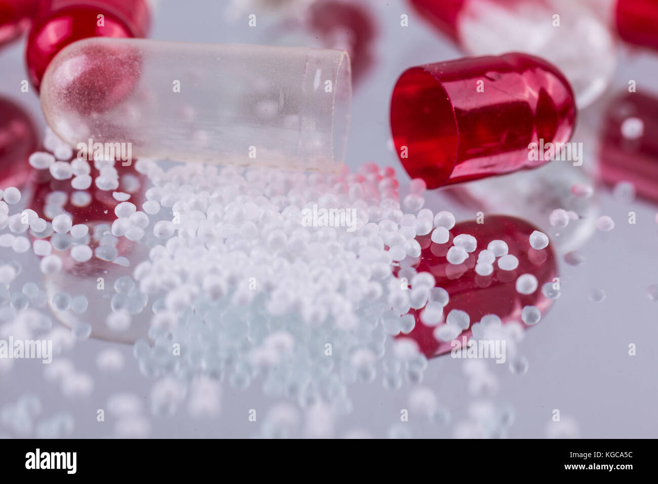 red-white capsules of them on a mirrored background Stock Photo - Alamy