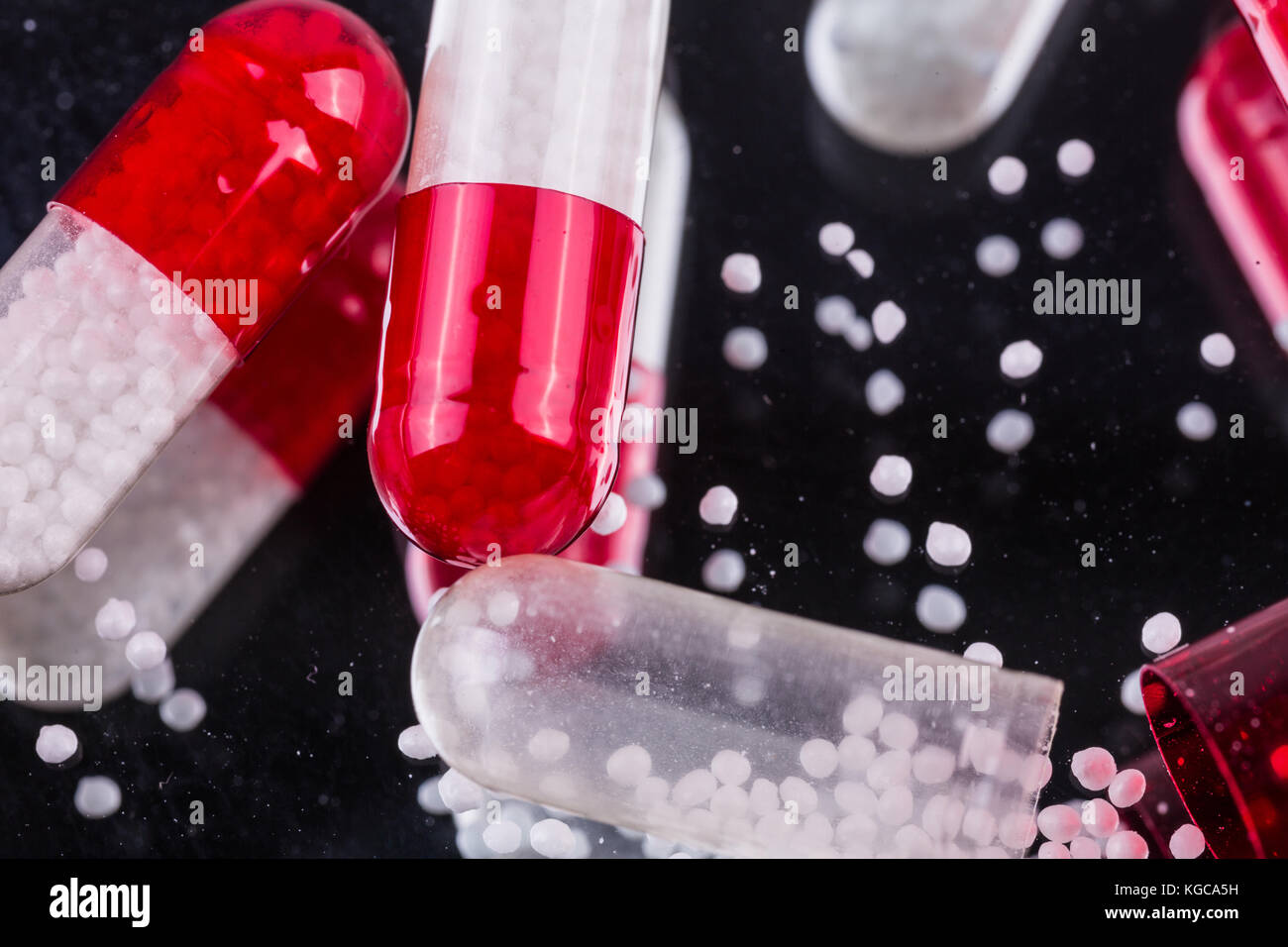 red-white capsules of them on a mirrored background Stock Photo - Alamy