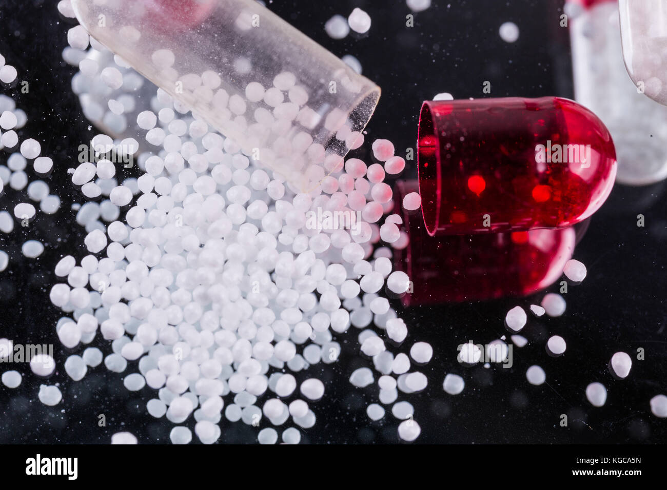 red-white capsules of them on a mirrored background Stock Photo - Alamy