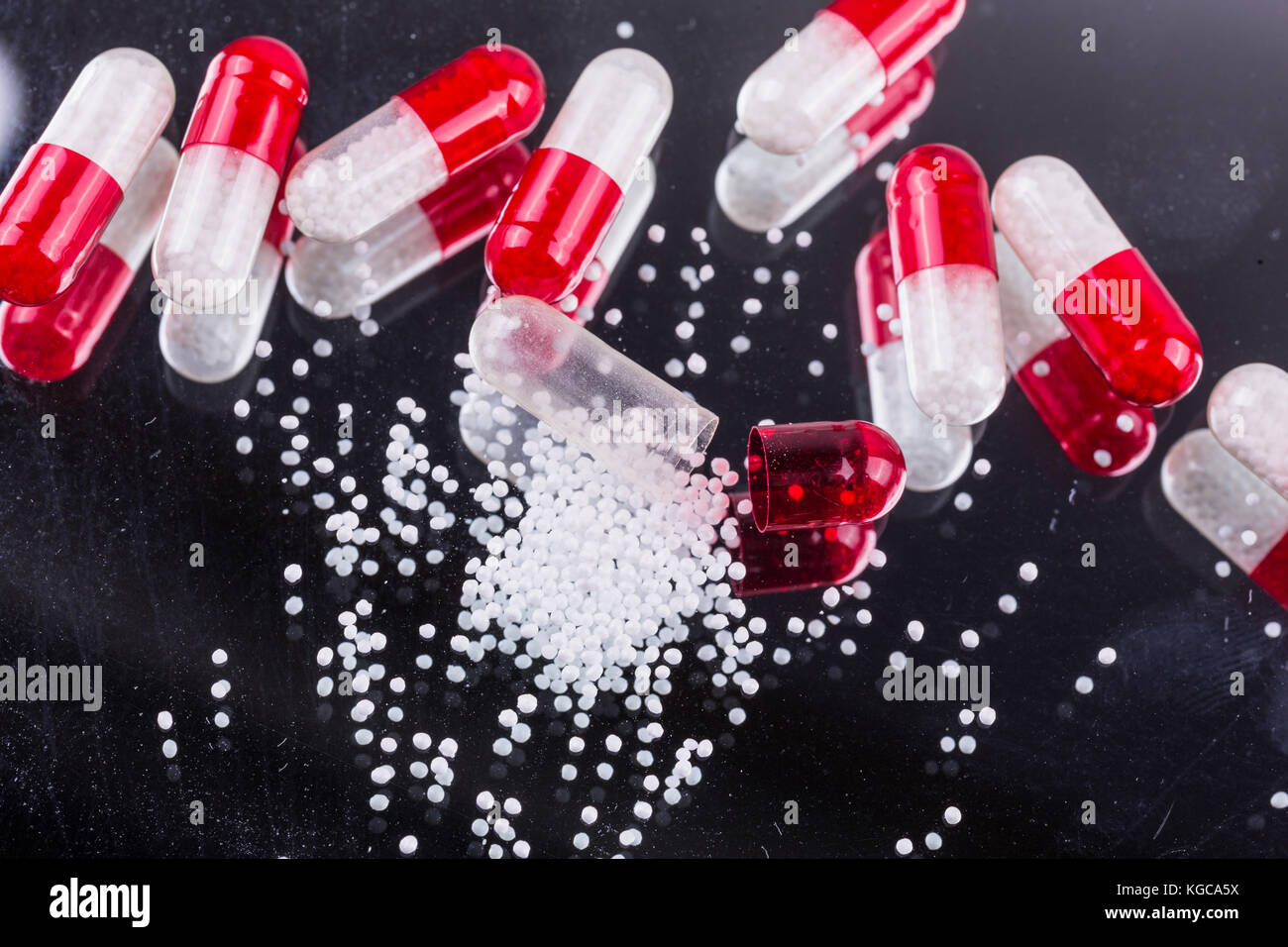 red-white capsules of them on a mirrored background Stock Photo - Alamy