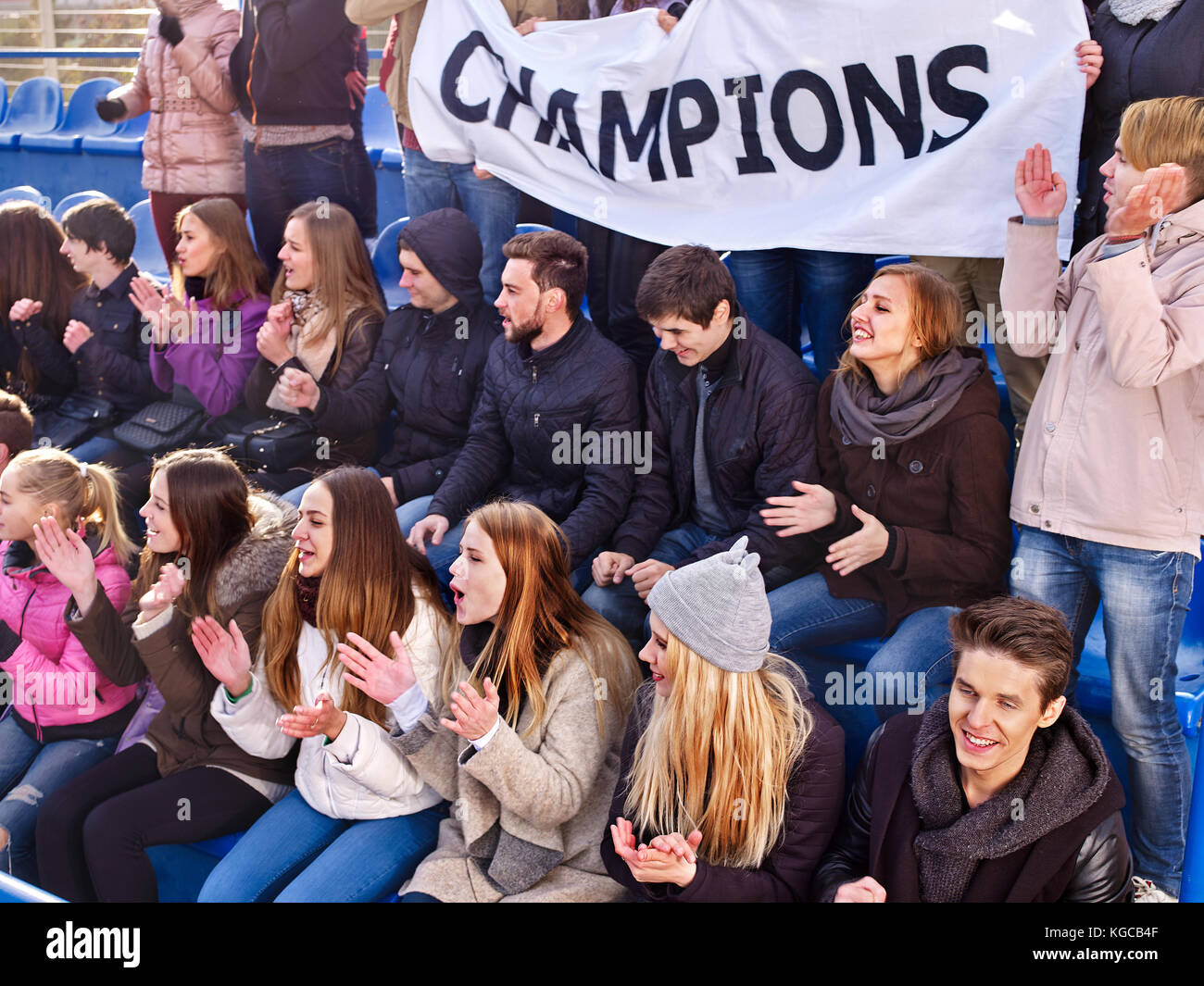 Fans cheering in stadium holding champion banner and singing on ...
