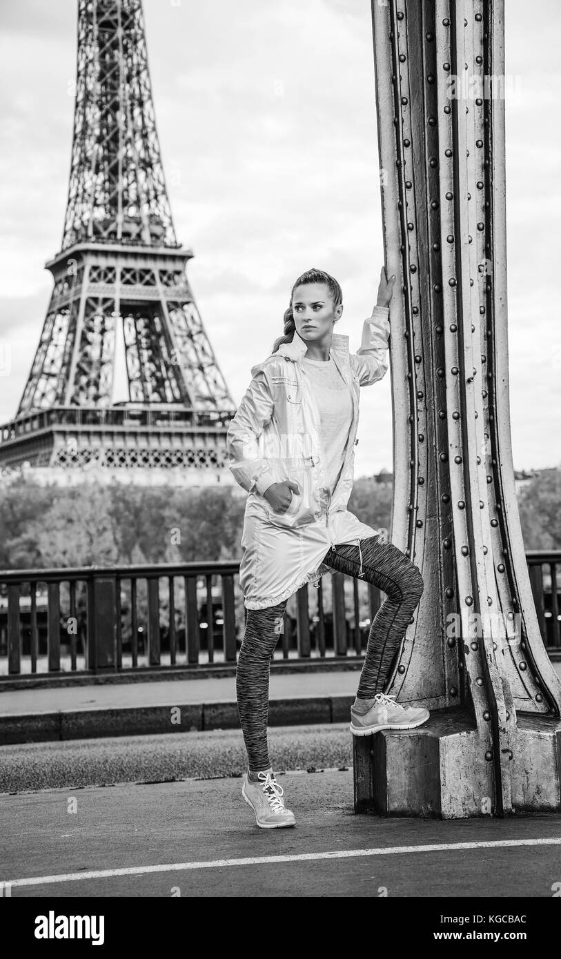 Year round fit & hip in Paris. young fit woman against Eiffel tower in ...