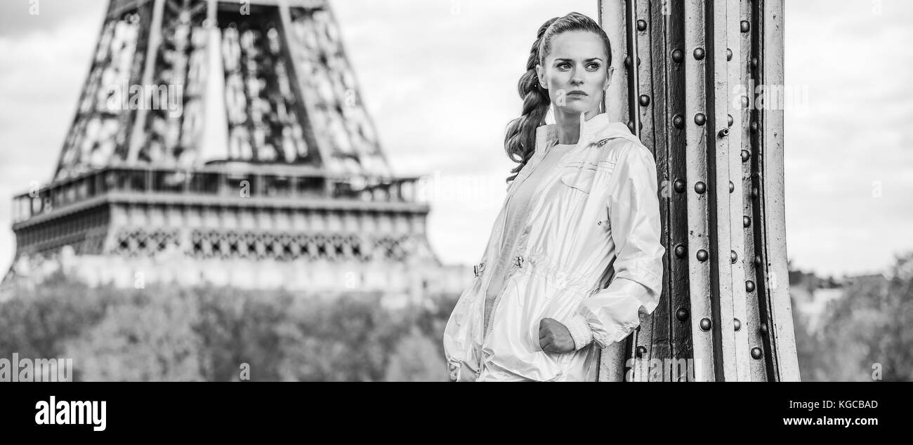 Year round fit & hip in Paris. young fitness woman against Eiffel tower ...