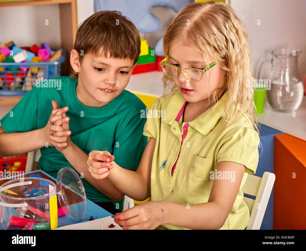 Plasticine modeling clay in children class. kids together play dough ...