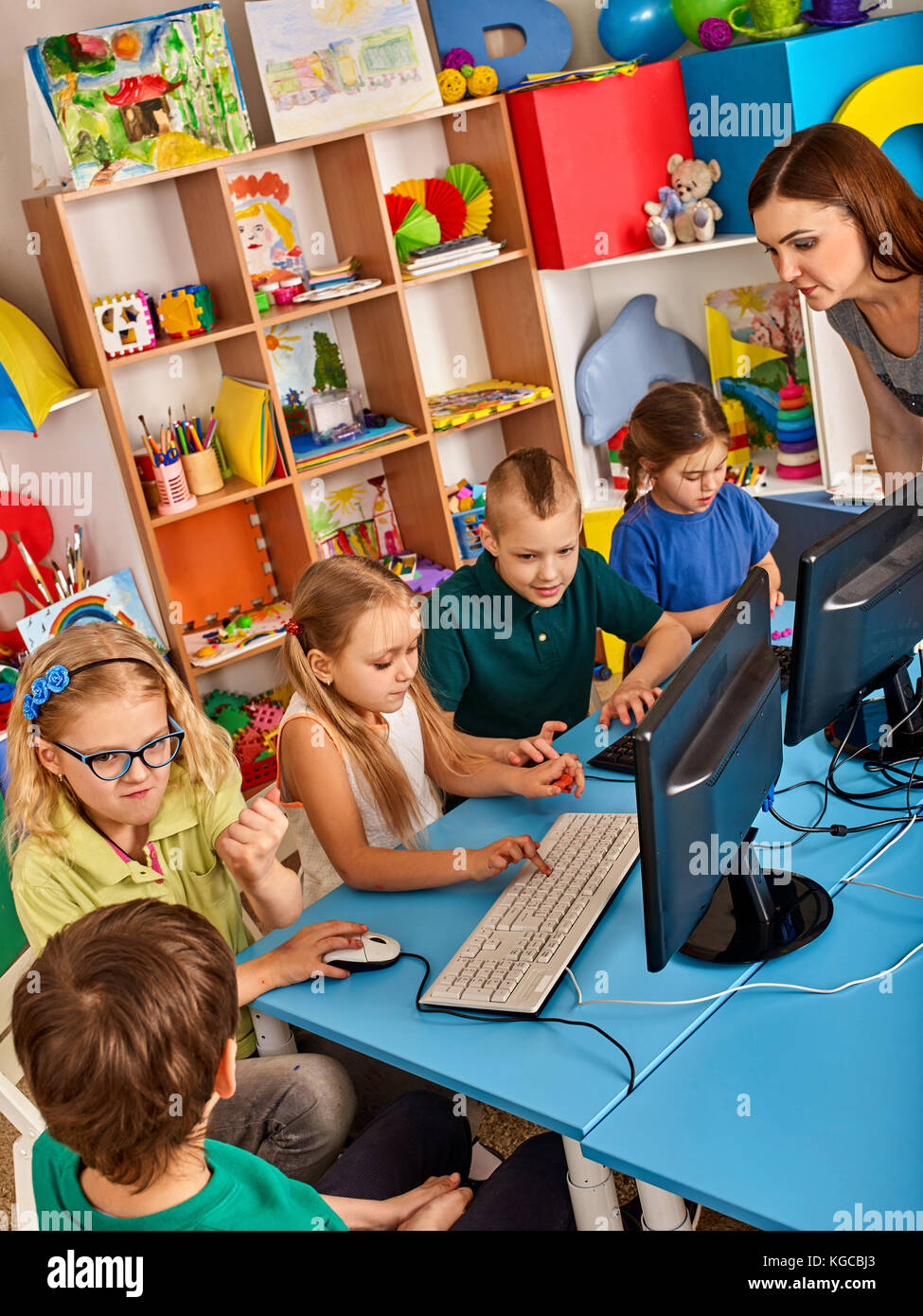 Children computer class us for education and video game. Boys and girls ...