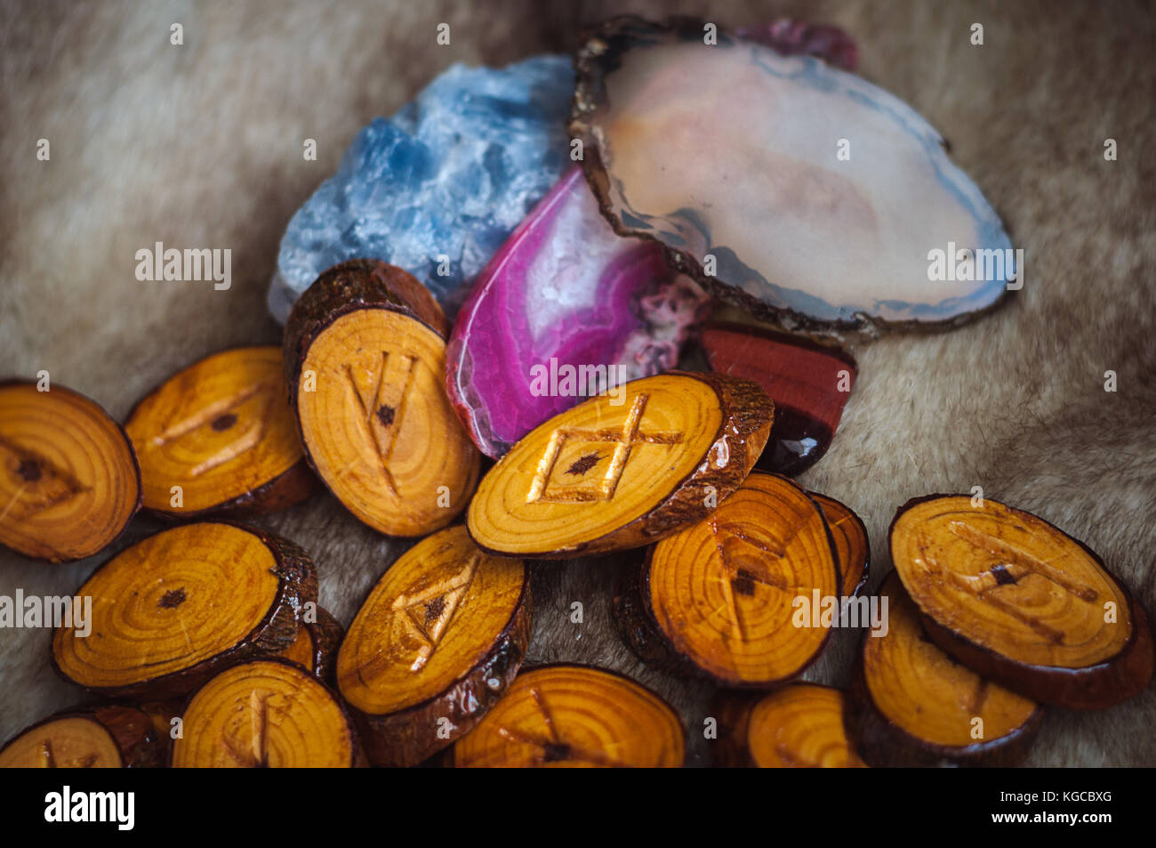 wood runes handmade fur are lying beside the crystal ball and semi ...