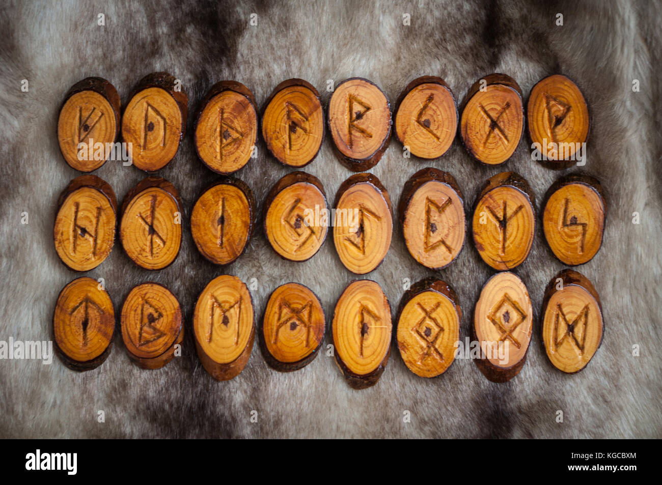 wood runes handmade fur are lying beside the crystal ball and semi ...