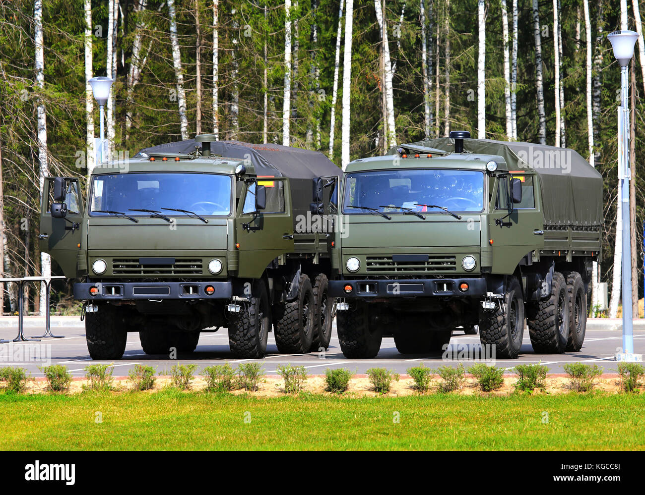 Two military passenger trucks of green color Stock Photo - Alamy