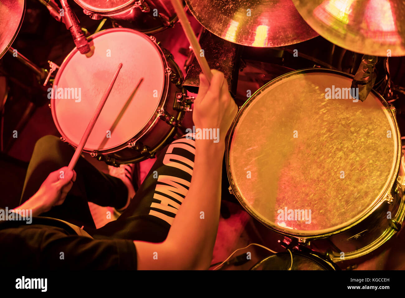 Drummer plays the drums at a concert in red light, the top view Stock ...