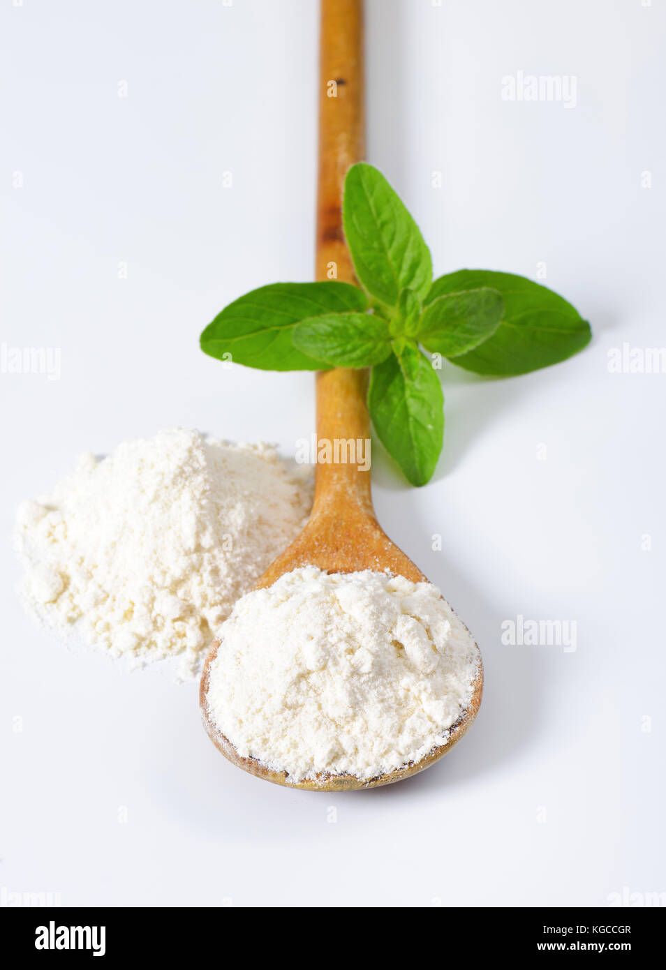 Wheat flour on wooden spoon and next to it Stock Photo - Alamy