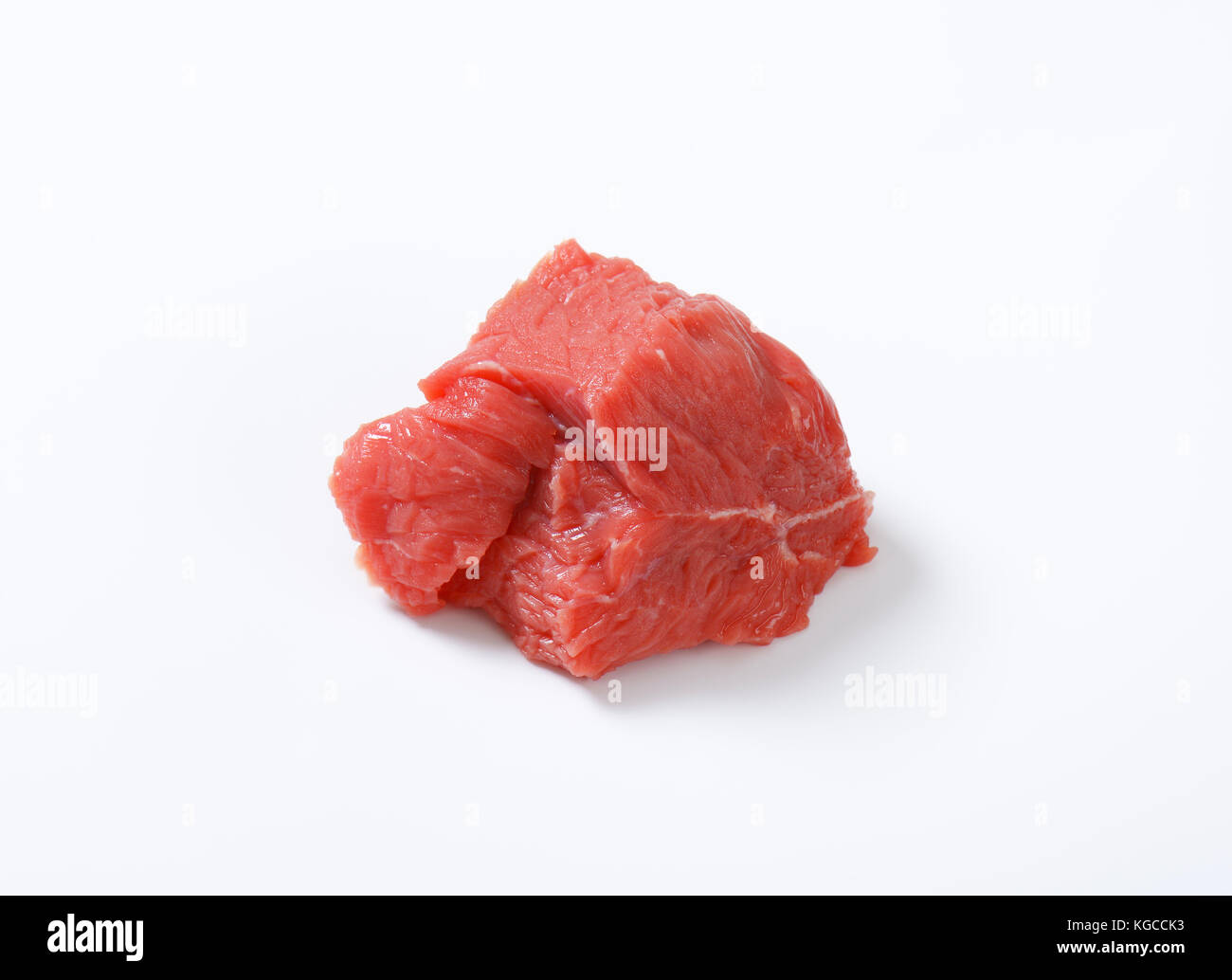 small piece of raw beef meat on white background Stock Photo - Alamy
