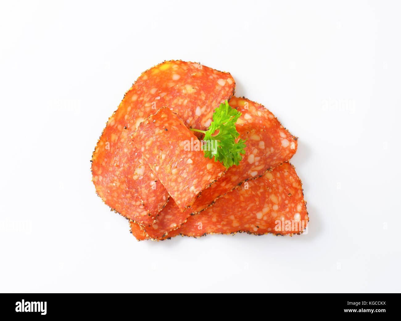 Thin slices of black pepper-coated salami speckled with pieces of Comte ...