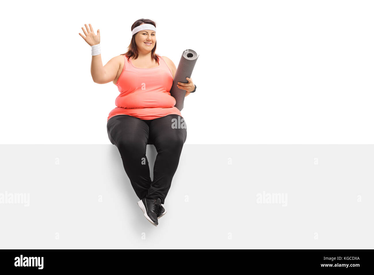 Overweight woman with an exercise mat sitting on a panel and waving at ...