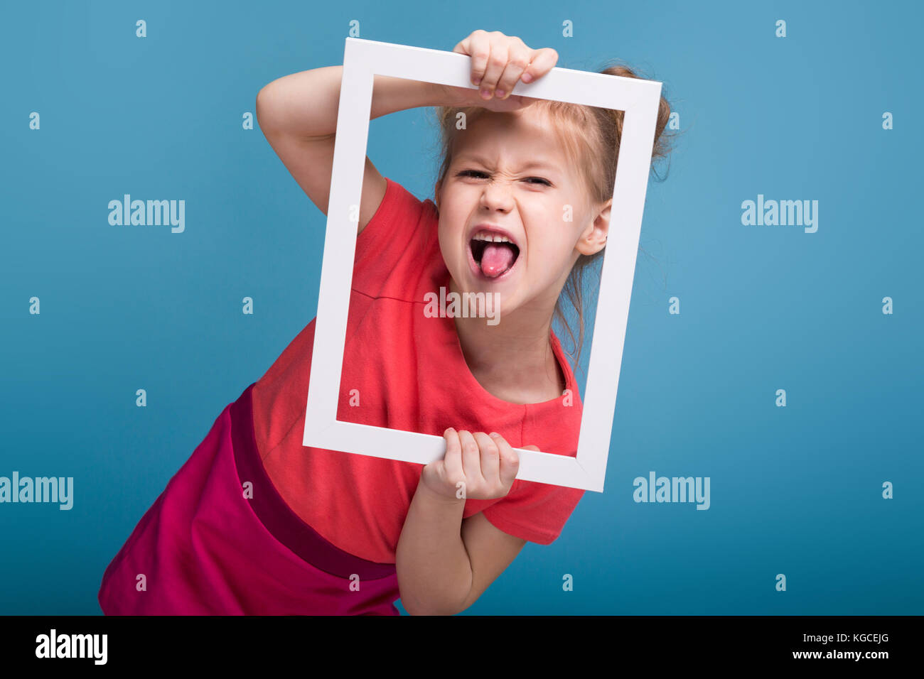 Beautiful cute little girl in pink dress holds picture frame Stock ...