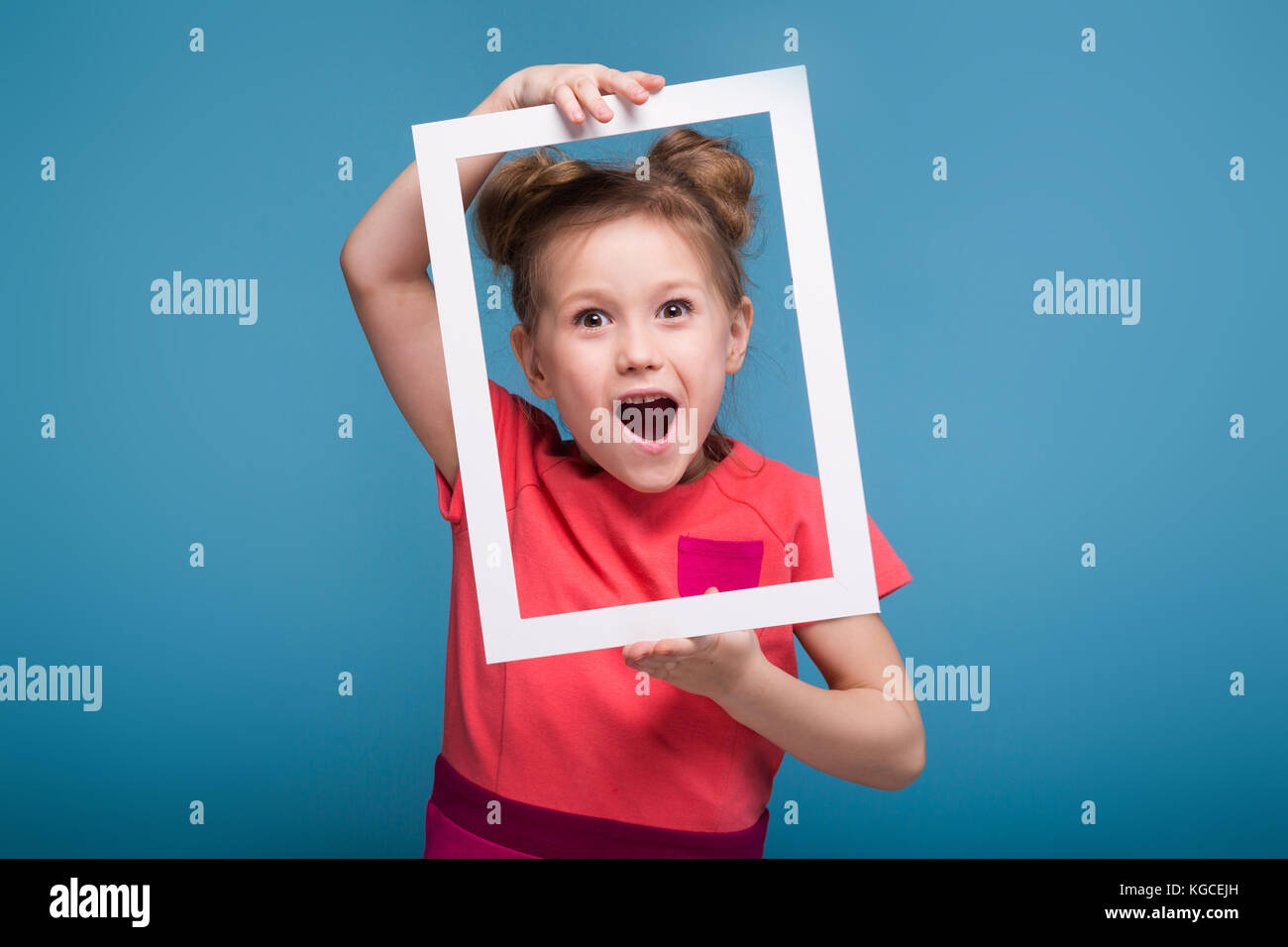 Beautiful cute little girl in pink dress holds picture frame Stock ...