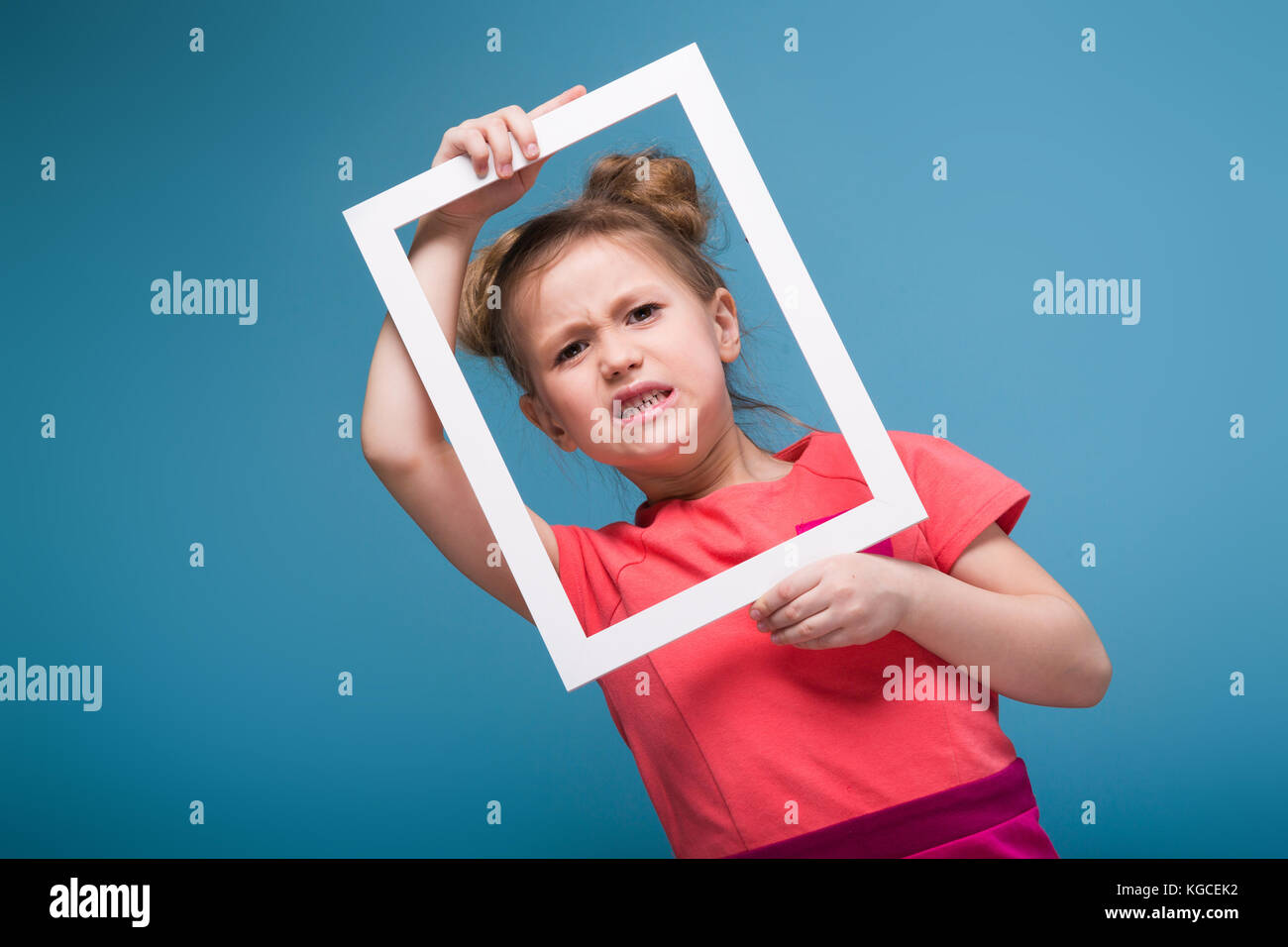 Beautiful cute little girl in pink dress holds picture frame Stock ...