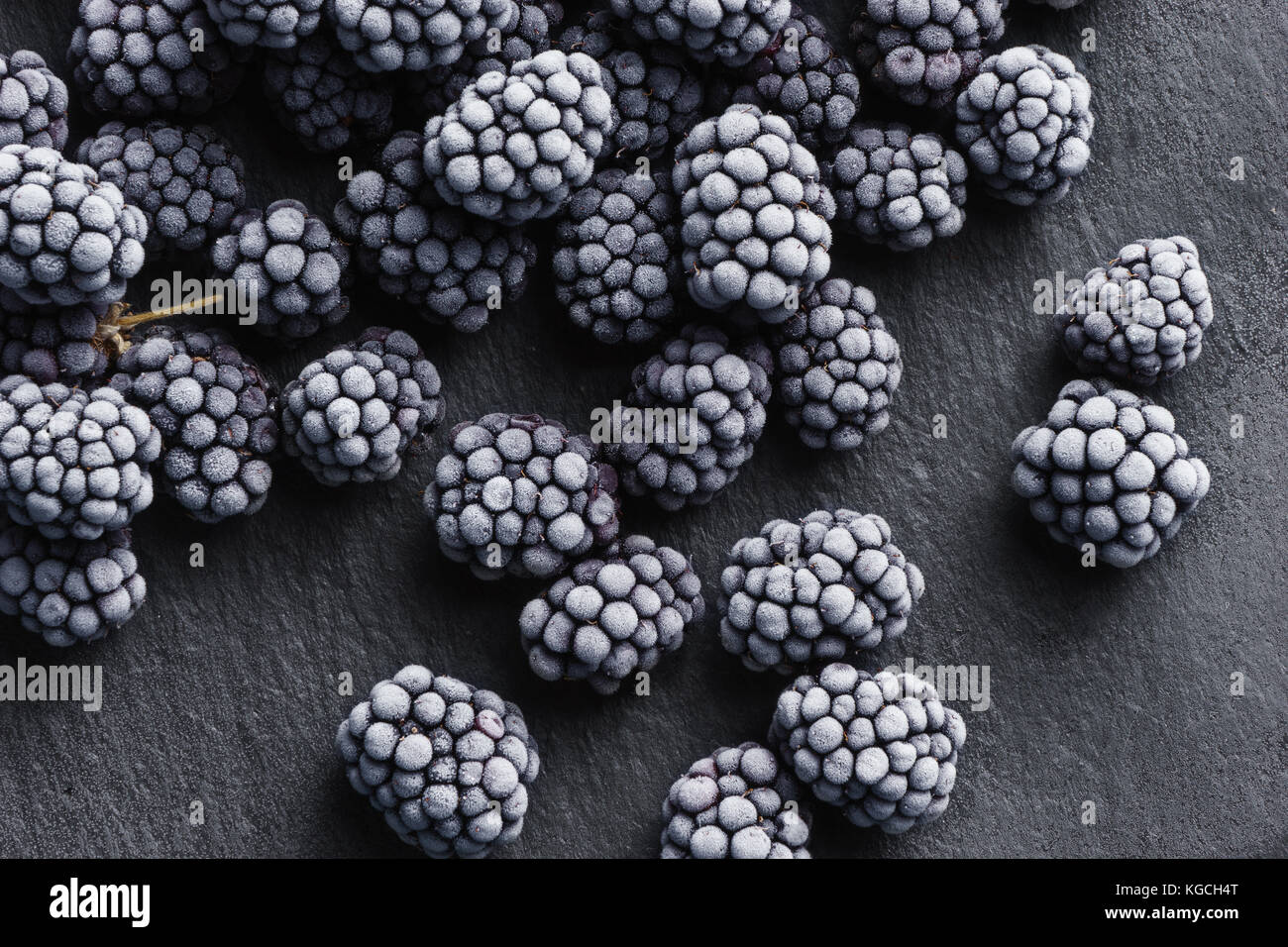 Frozen blackberry on black slate. Close up. Top view. High resolution ...